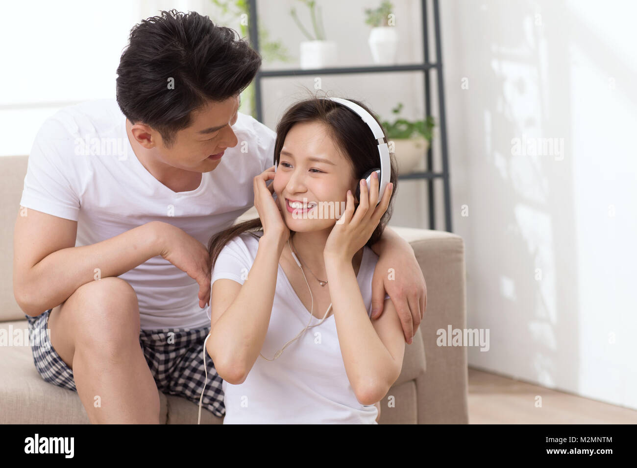 Romantic lovers listen to music Stock Photo - Alamy