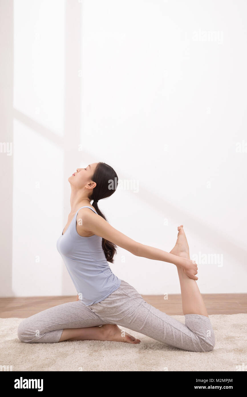 Young women practice yoga Stock Photo - Alamy