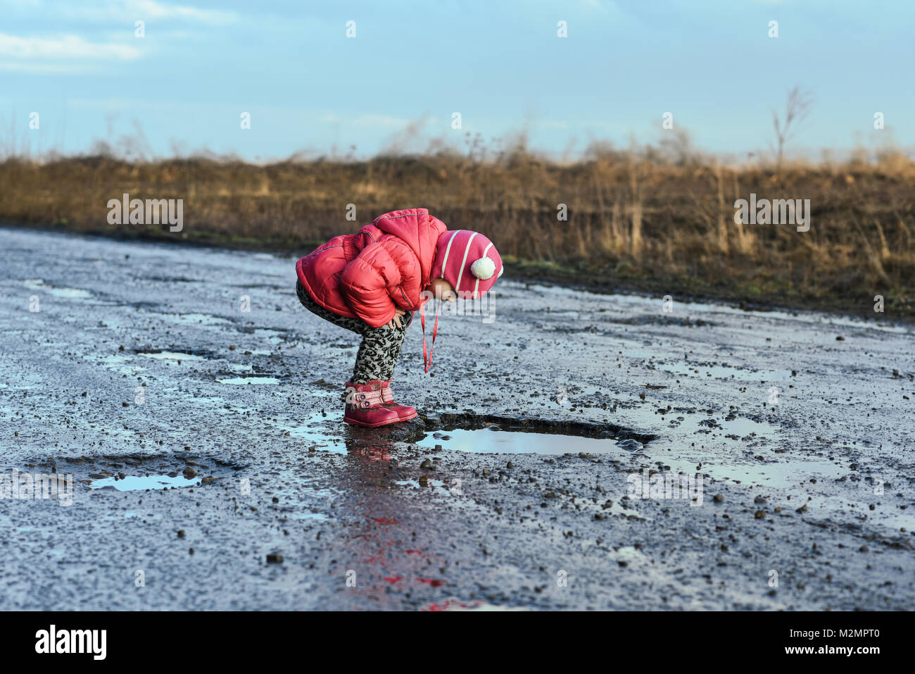 Little girl looking into puddle, children, unforgettable moments, fun ...