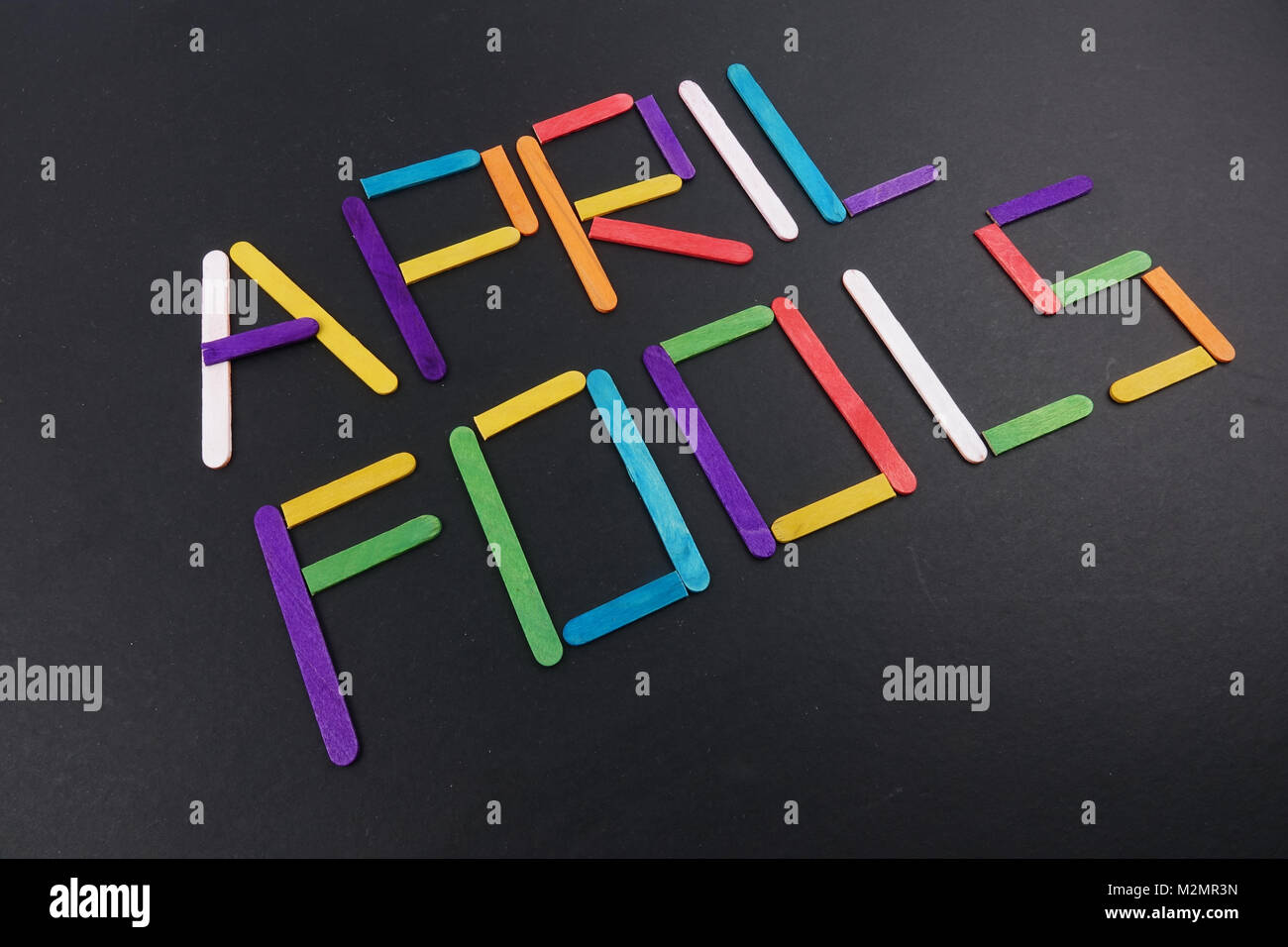 April Fools background with colourful sticks on black background Stock ...
