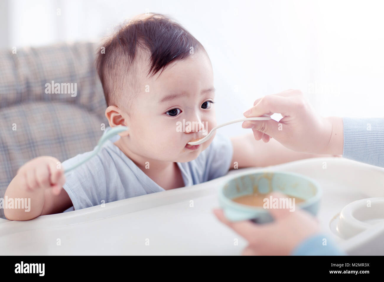 The lovely baby boy is eating Stock Photo - Alamy
