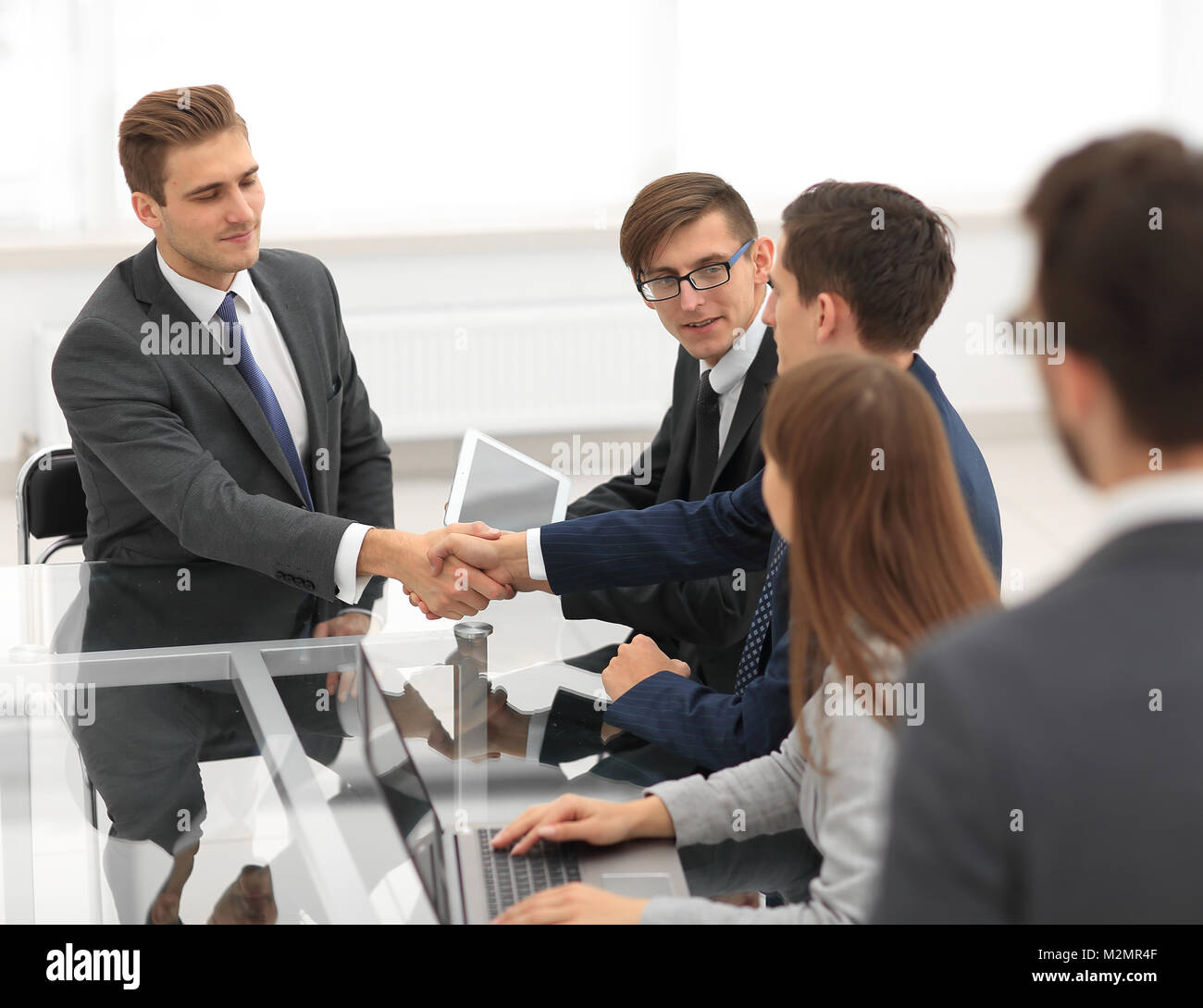 Businessmen making handshake in an office Stock Photo - Alamy