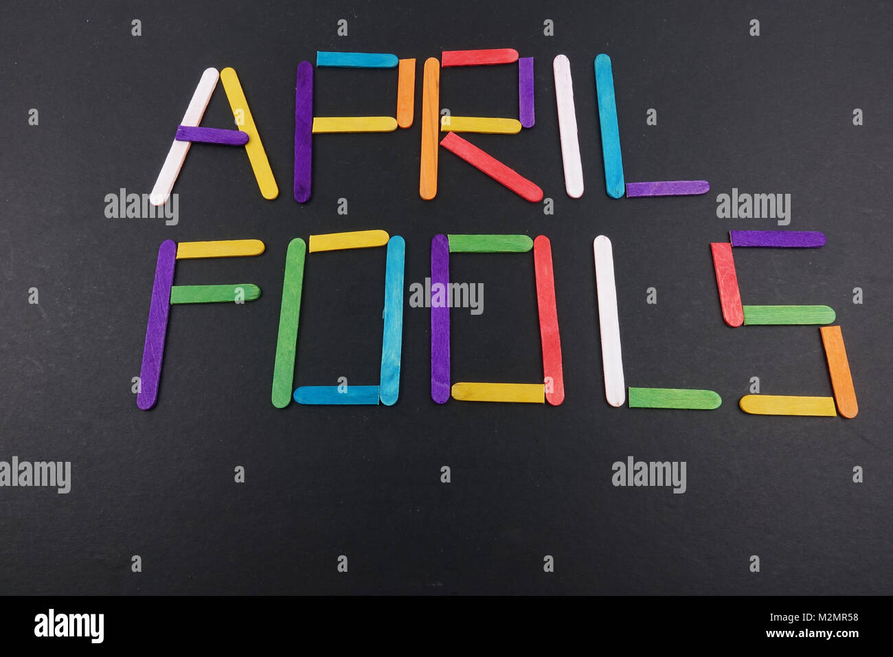April Fools background with colourful sticks on black background Stock ...
