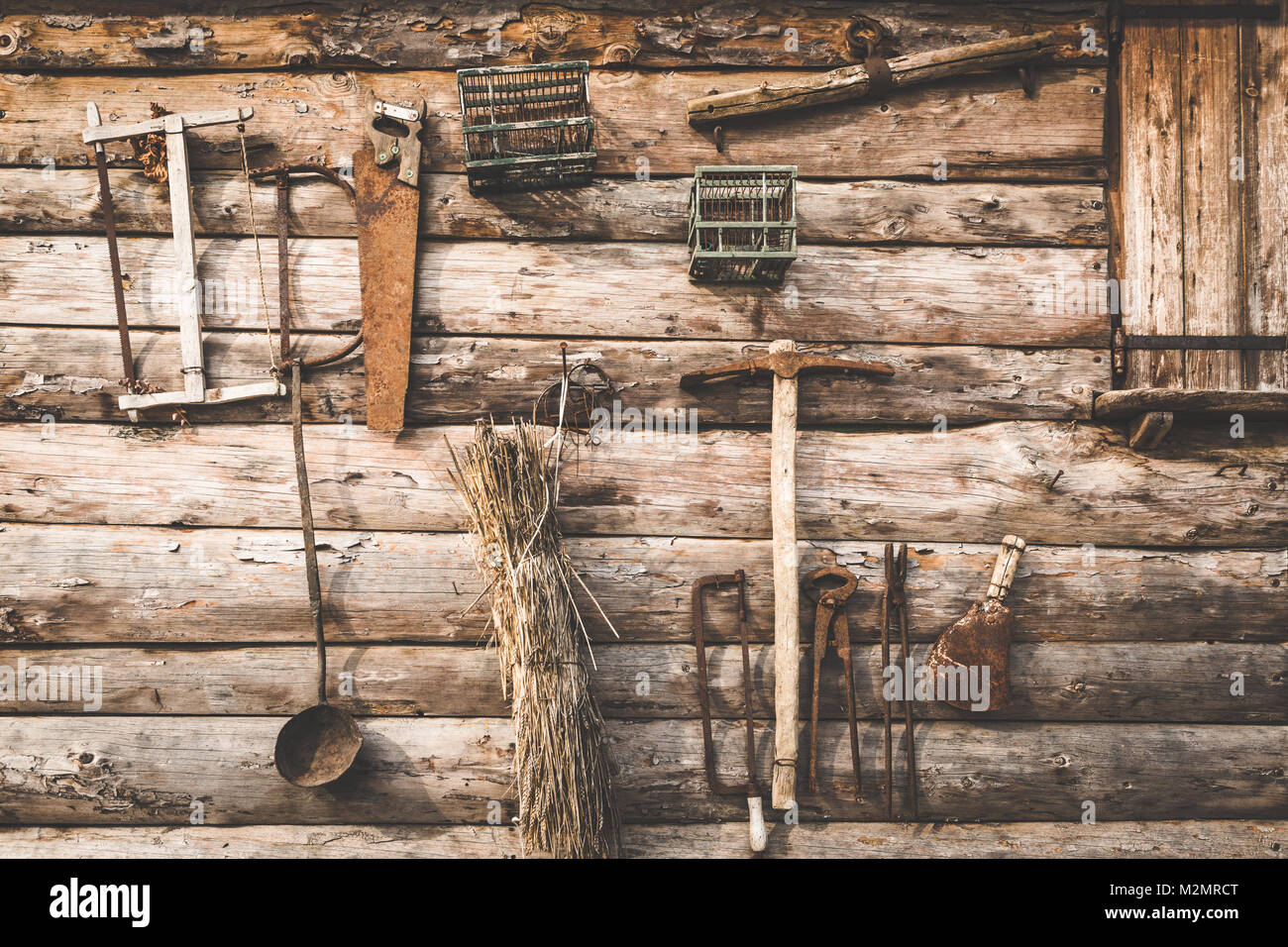 Collection of vintage rusty tools displayed on a old wooden background ...