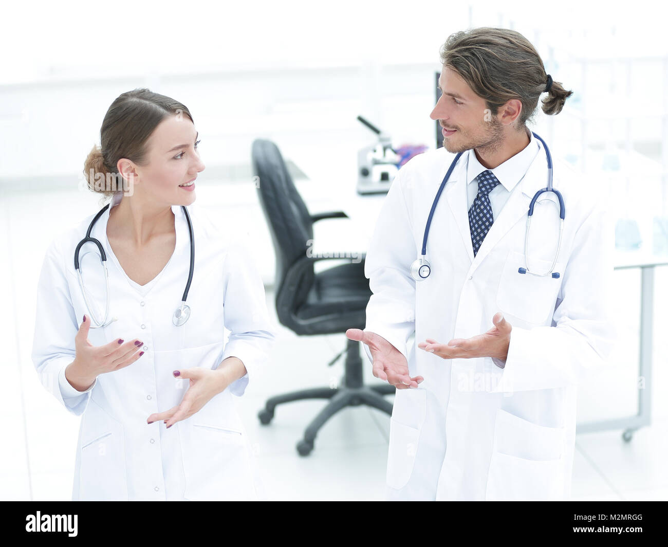 Two Doctors Having Meeting In Hospital Reception Area Stock Photo - Alamy
