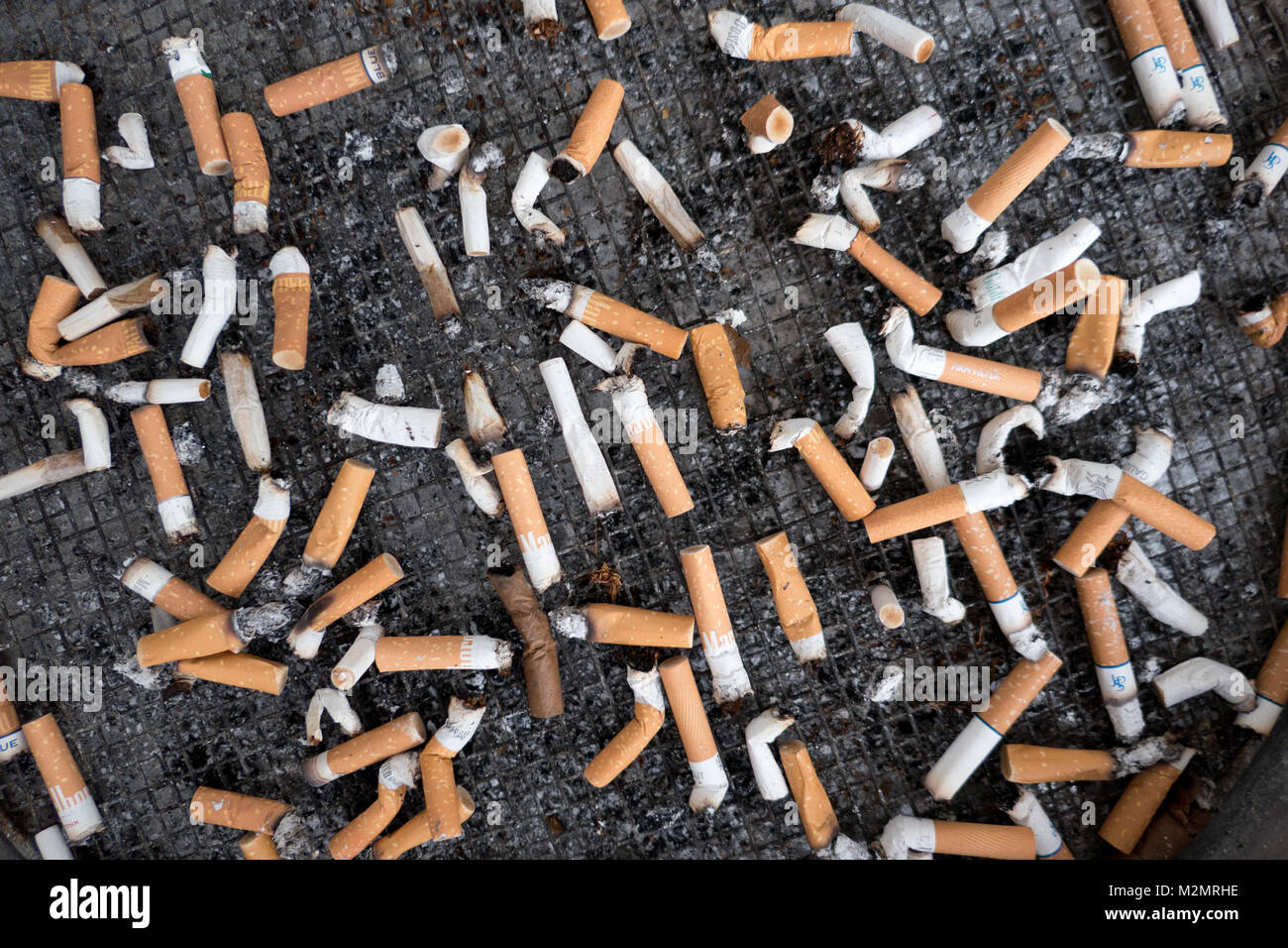 used cigarettes in an ashtray, perspective from top Stock Photo - Alamy