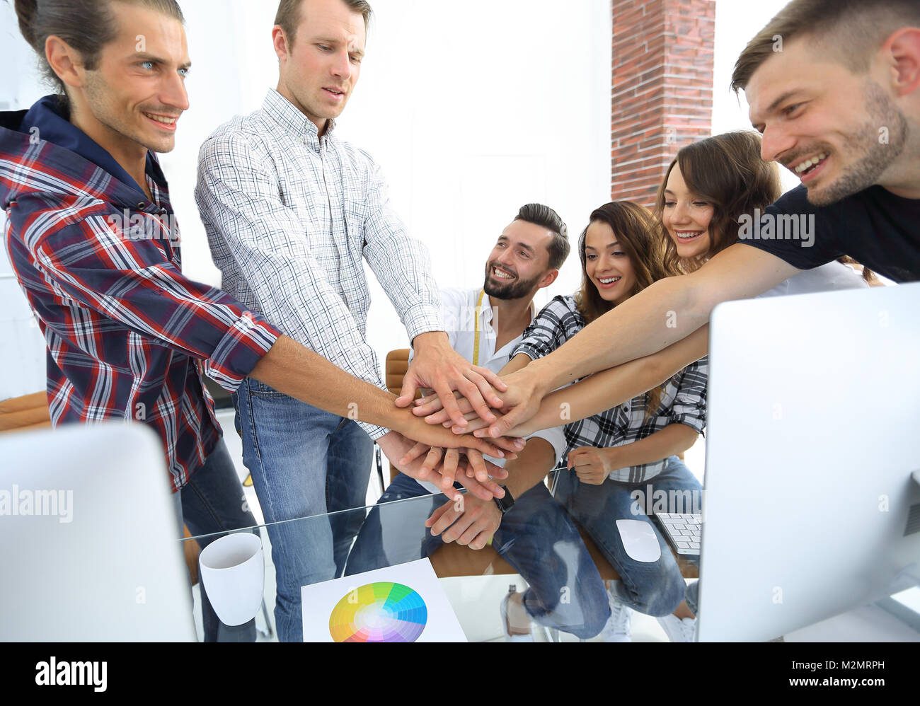 team of designers shows their success Stock Photo - Alamy