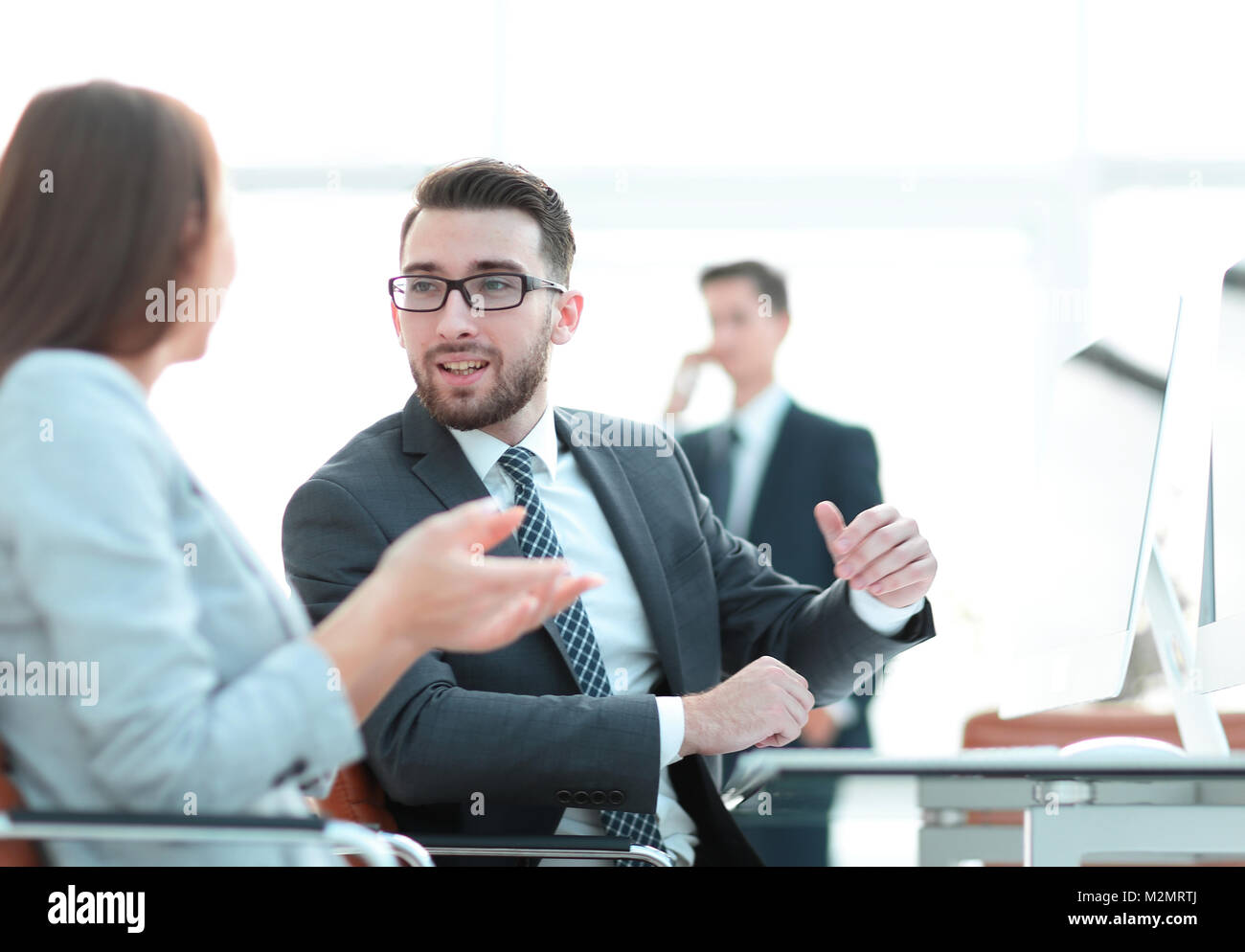 business colleagues talking at their Desk Stock Photo - Alamy