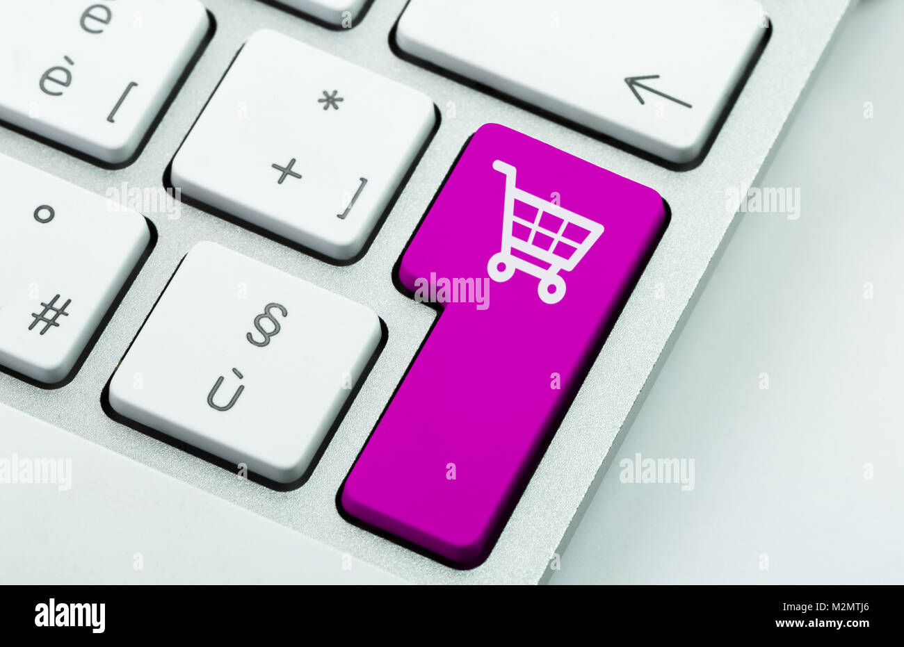 Computer notebook keyboard with icon shopping cart on key. E-commerce ...