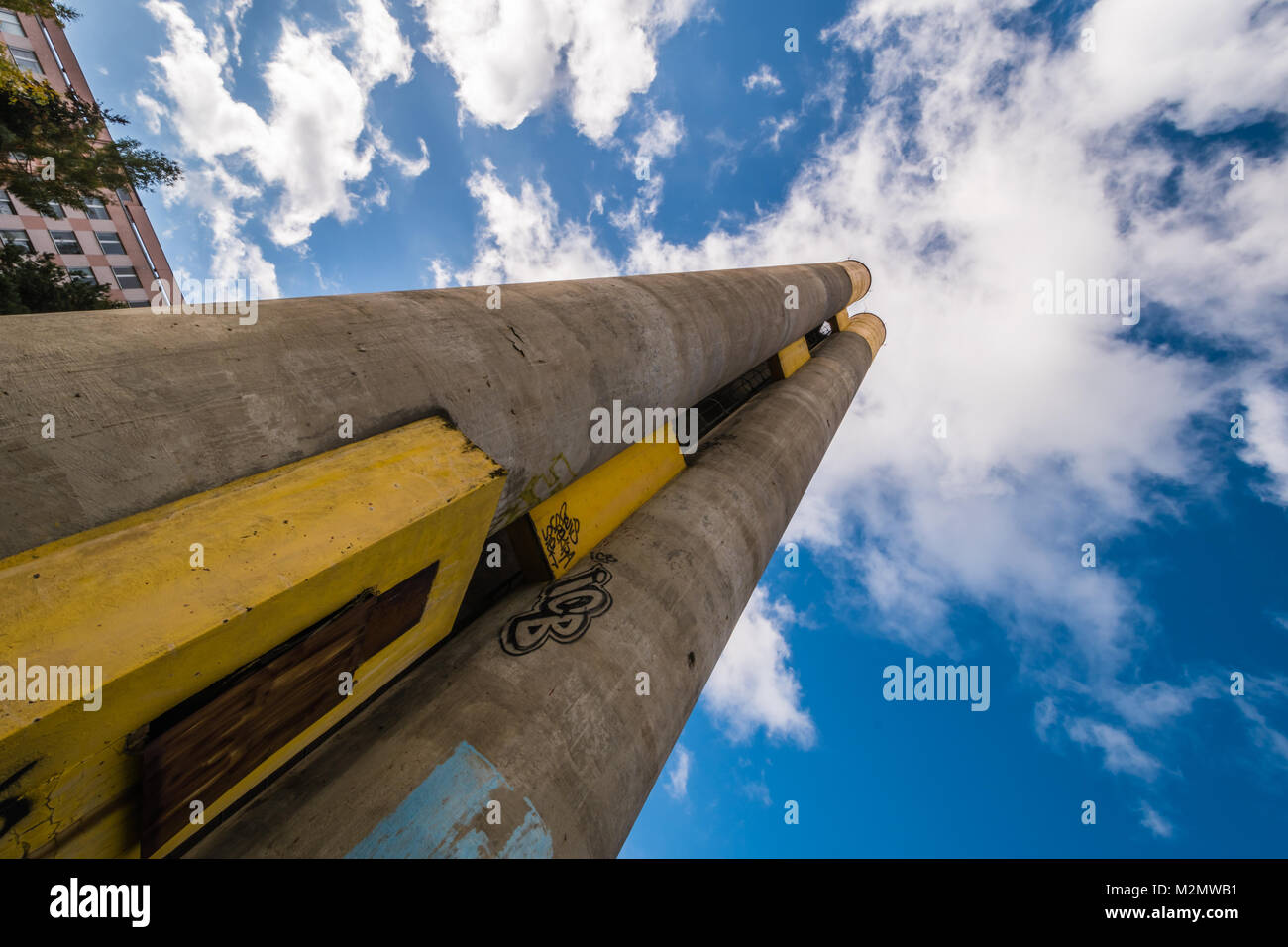 Very high chimney in the Prague housing estate with graffiti. View from ...