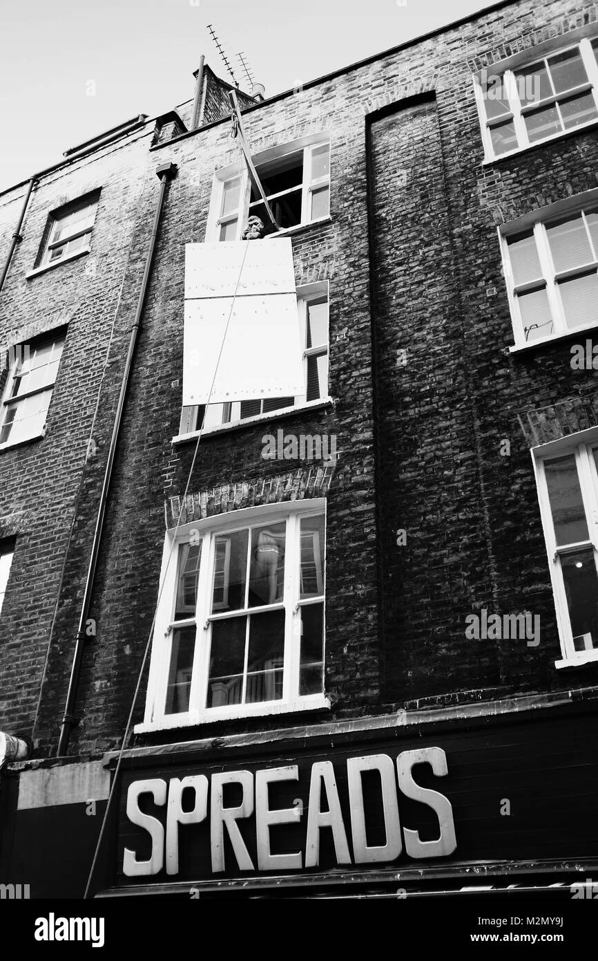 Black & White Photograph of a man pulling up sheet of hardwood, Covent ...