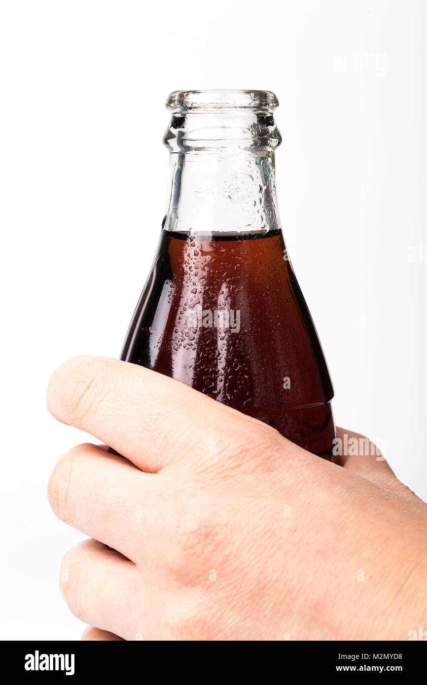Hand holding a red soda coke bottle. Isolated on white background Stock ...