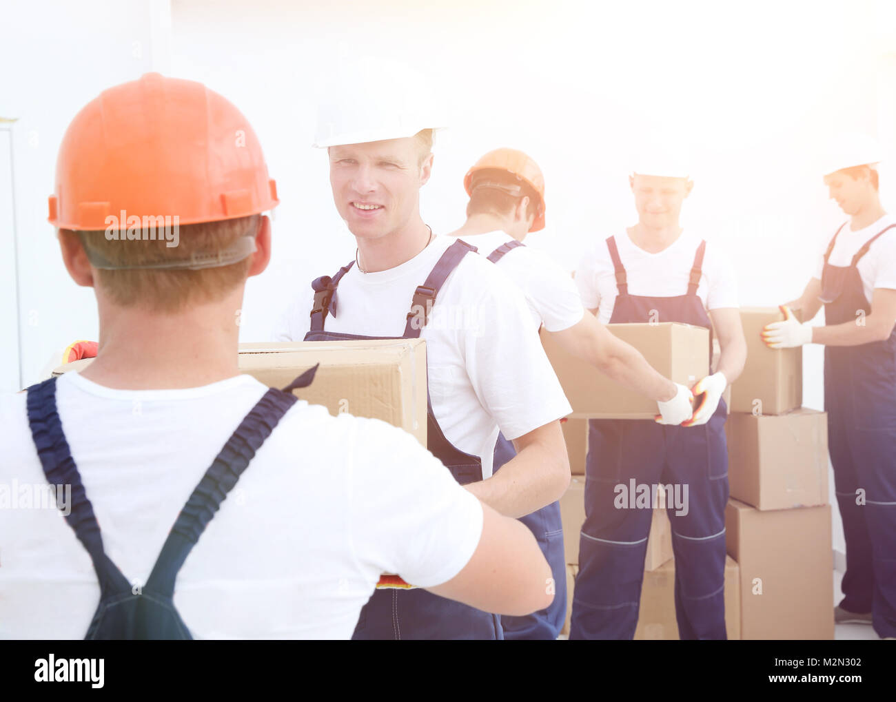 Group of people builders with boxes Stock Photo - Alamy