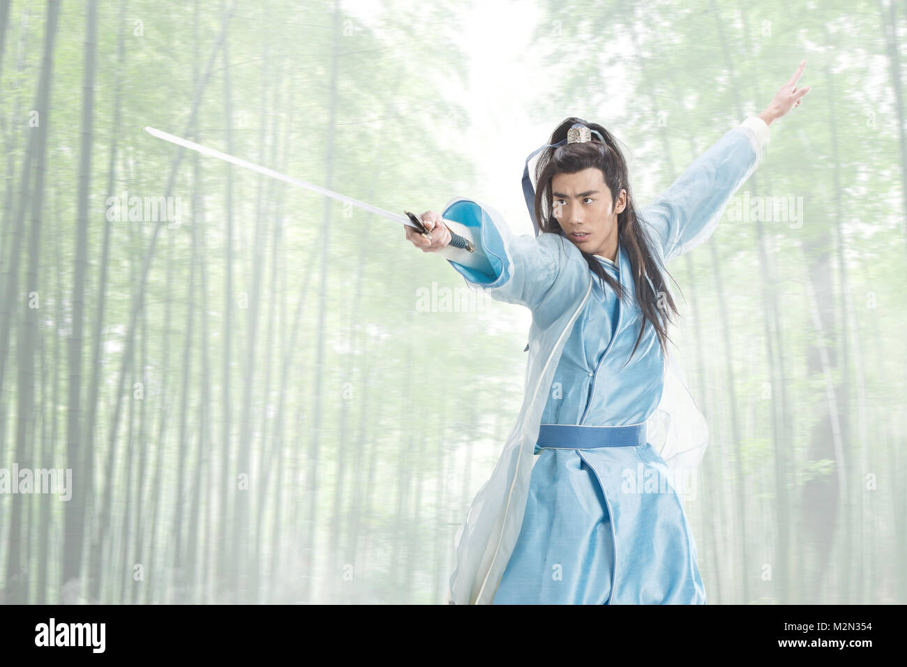 Holding a sword costume handsome boy Stock Photo - Alamy