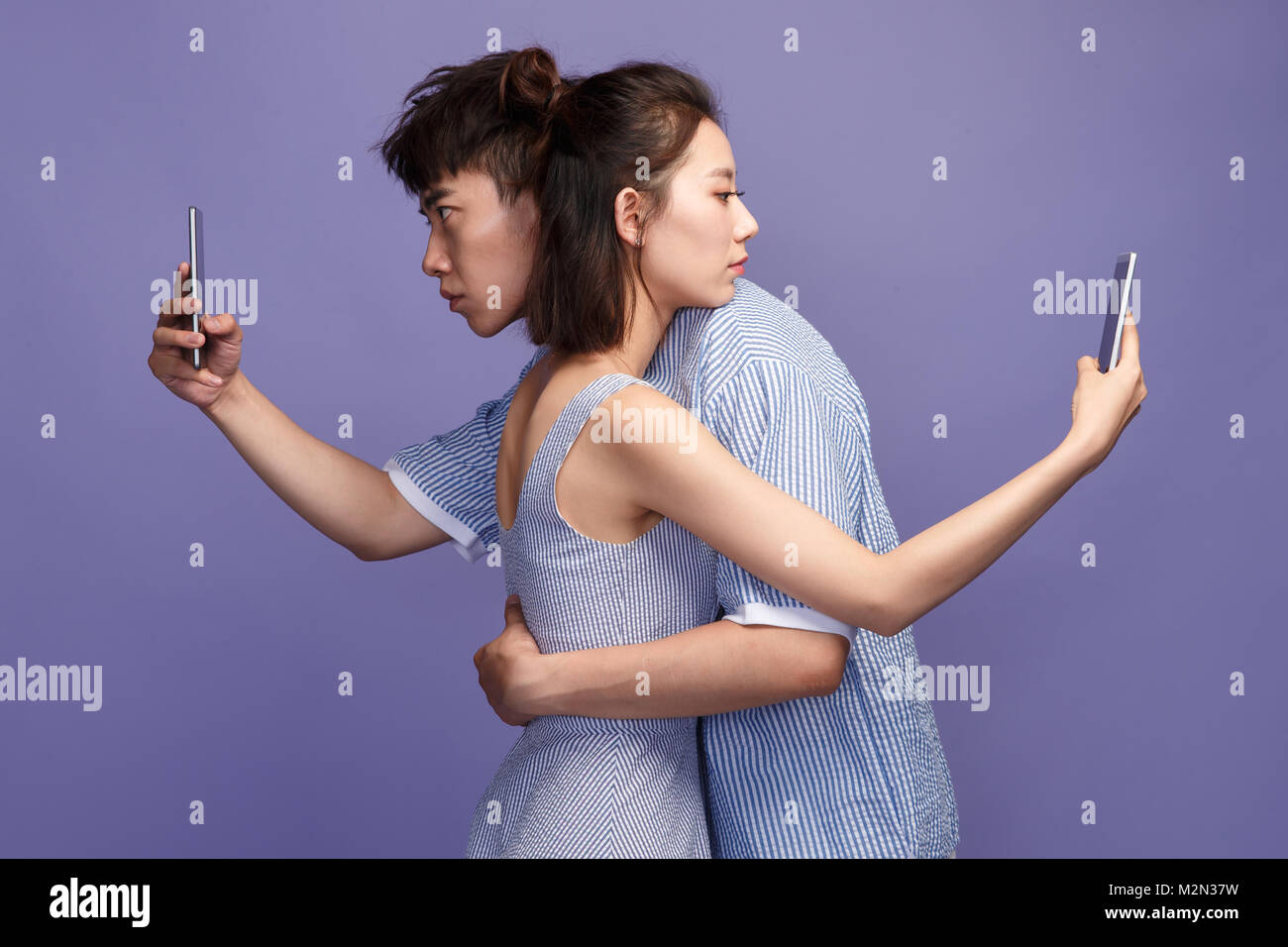 Young couples playing mobile phone Stock Photo - Alamy
