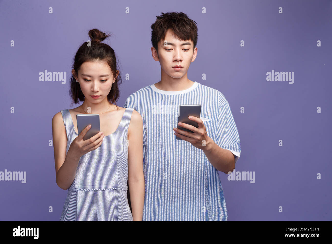 Young couples playing mobile phone Stock Photo - Alamy
