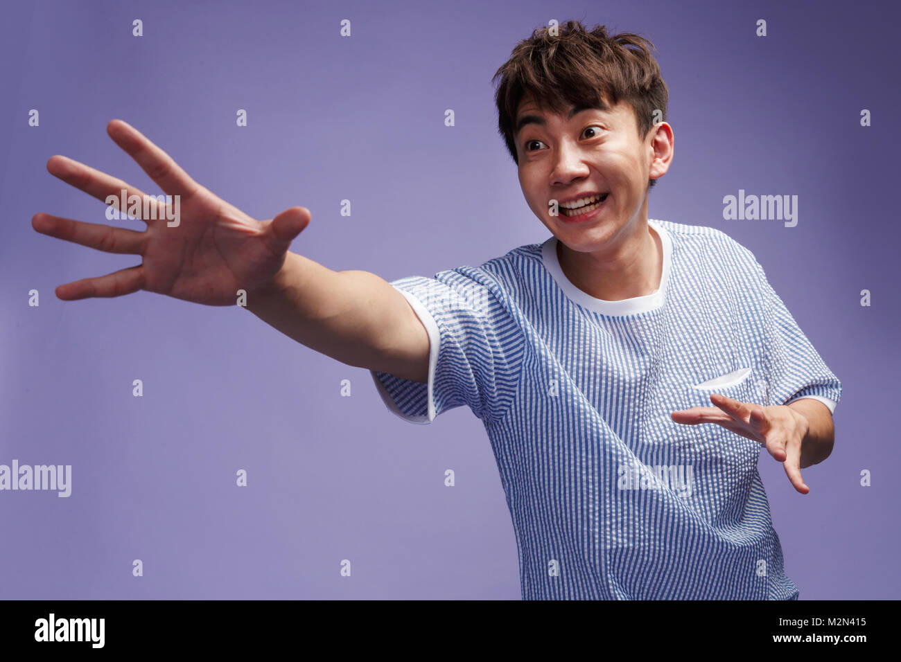 The young man stretched out his hand to grasp Stock Photo - Alamy