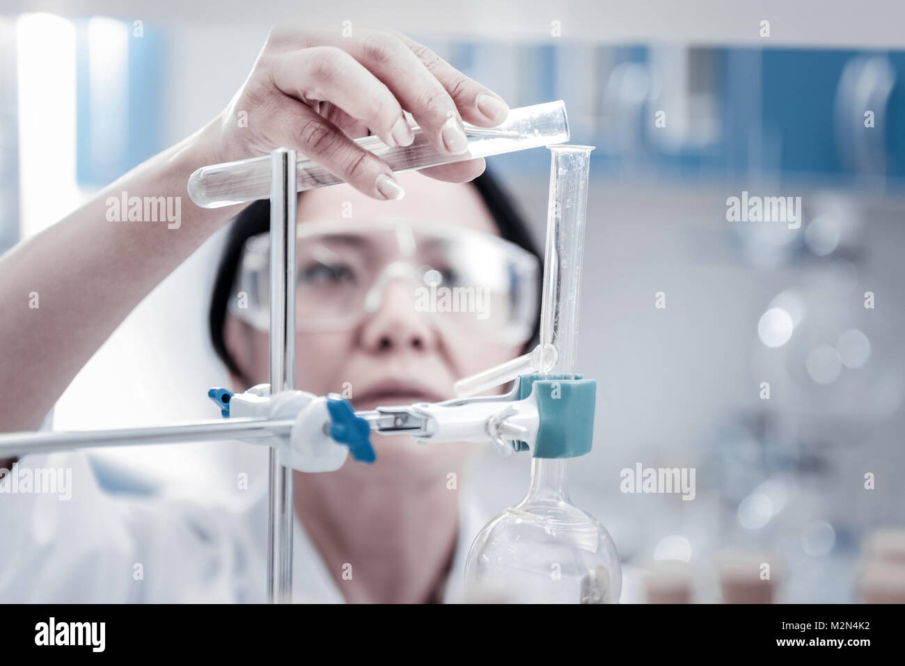 Female researcher conducting chemical experiment in laboratory Stock ...
