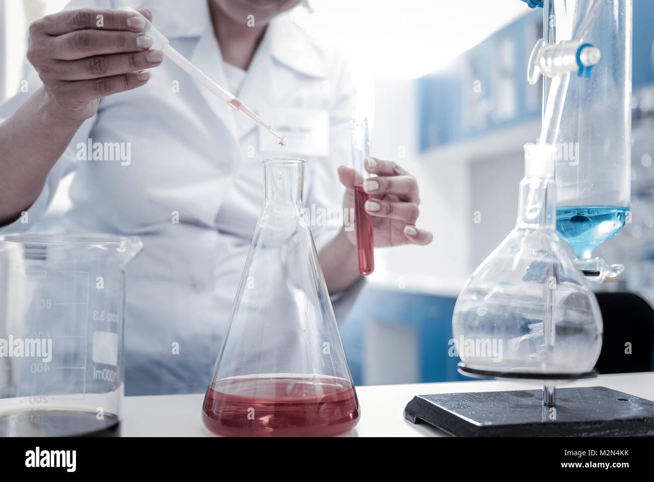 Close up of female chemist conducting experiment in lab Stock Photo - Alamy