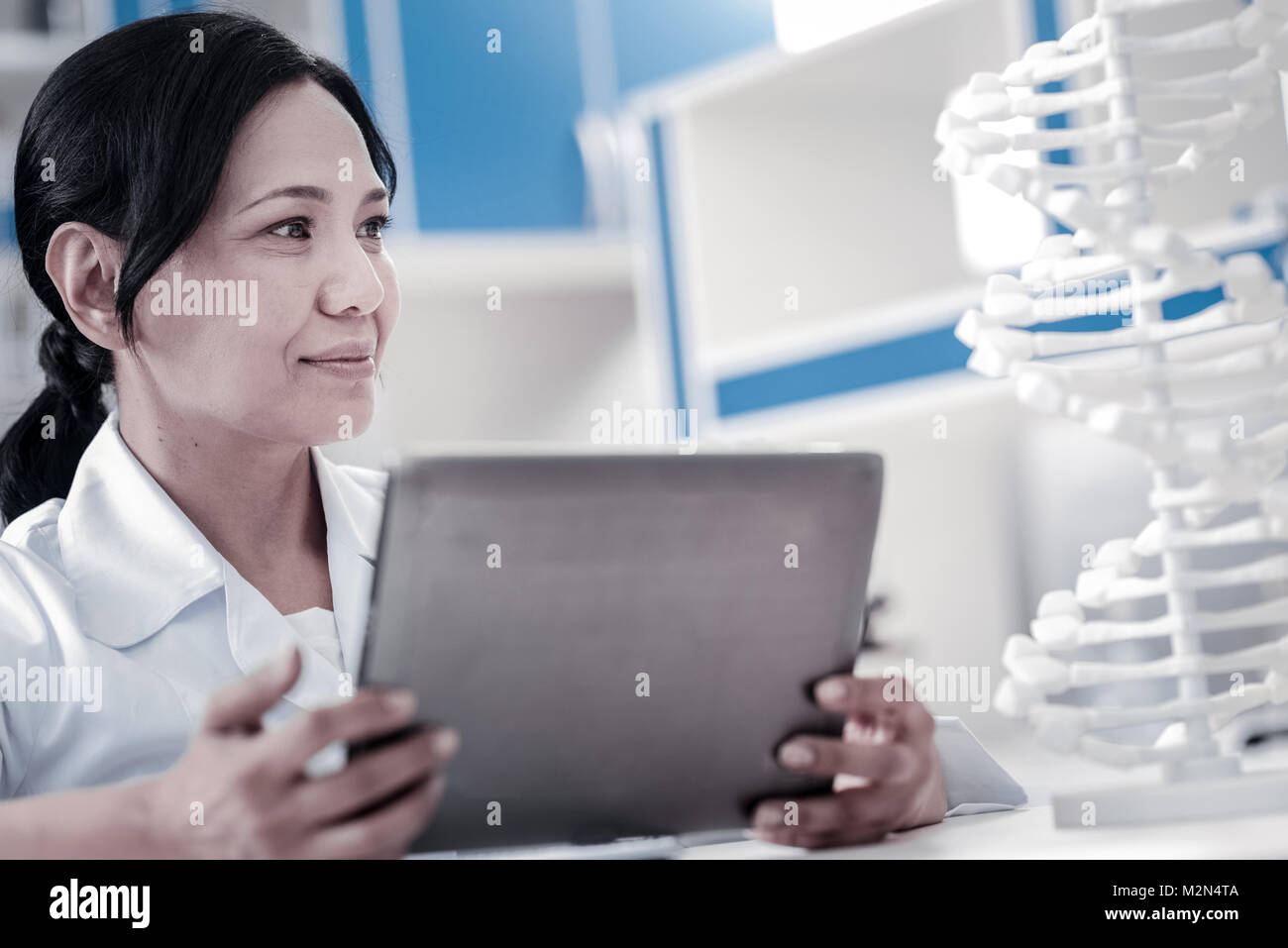 Joyful female scientist examining three dimensional model of dna Stock ...