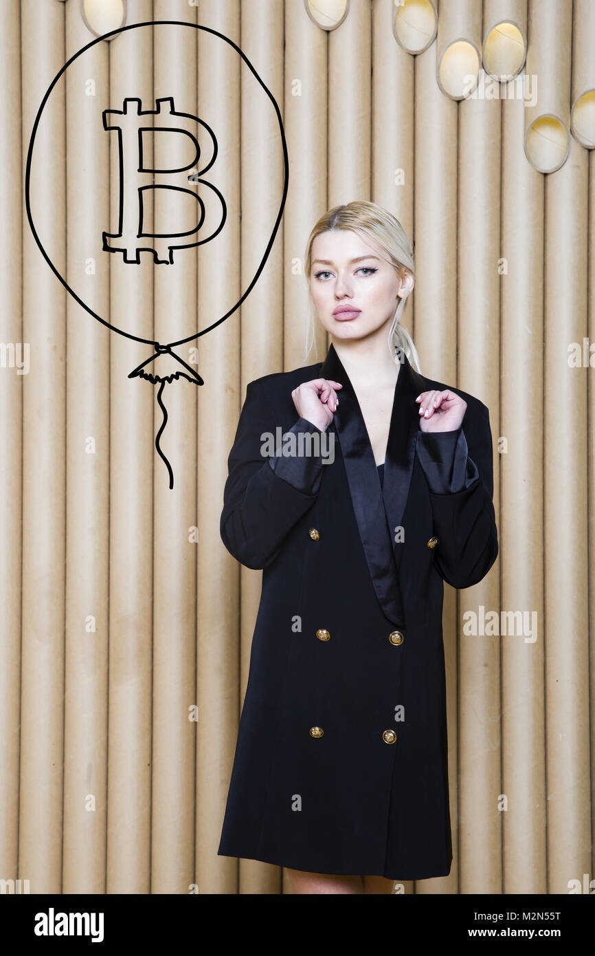 Beautiful blond woman showing standing near bitcoin sketch. Virtual ...