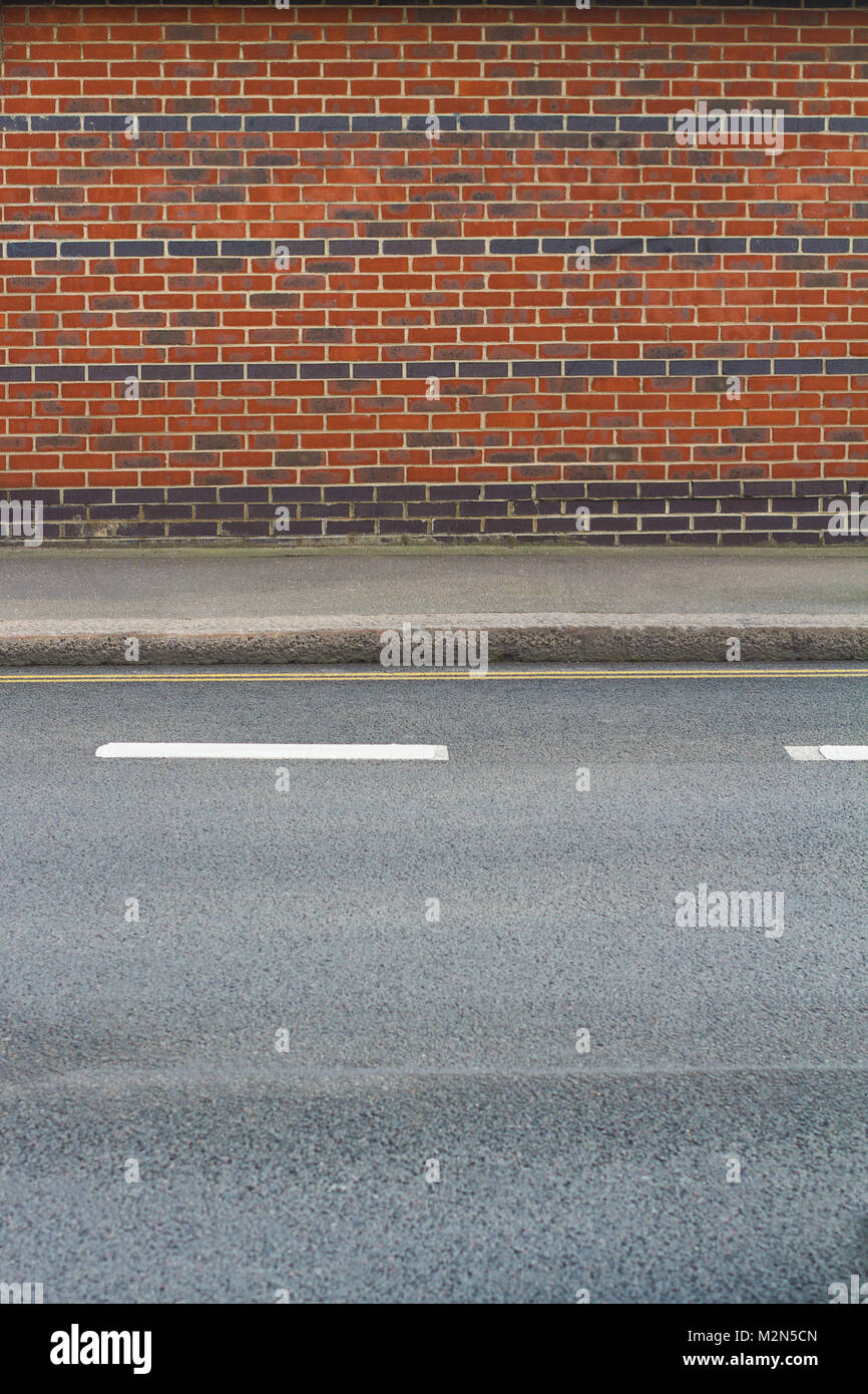 front view detail of brick wall near a sidewalk and street Stock Photo ...