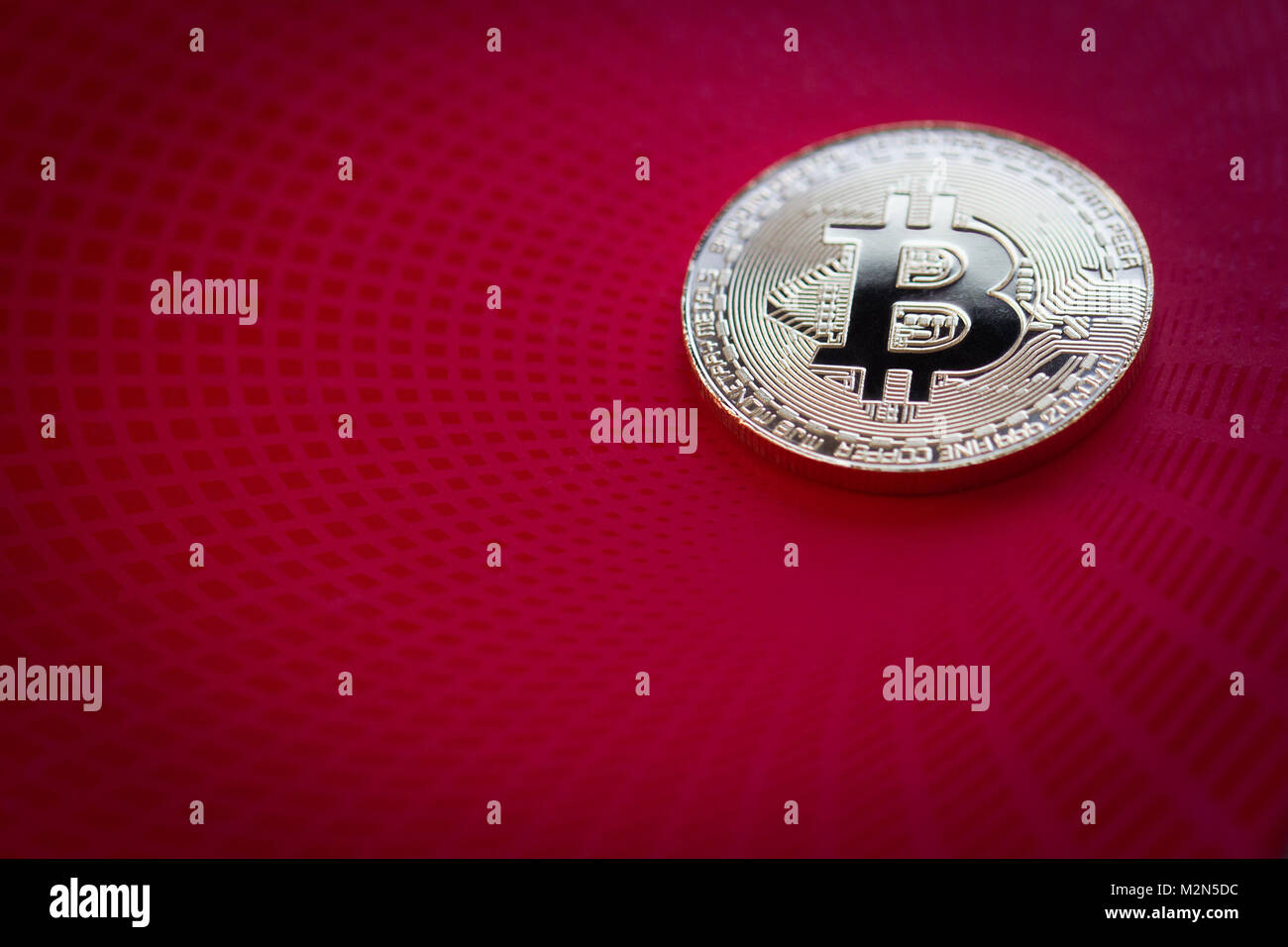 horizontal top view closeup of bitcoin golden metallic coin on red ...