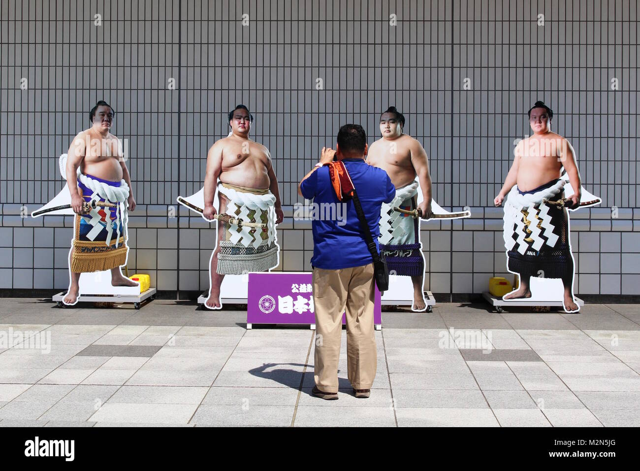 Large cutouts of sumo wrestlers in front of Ryogoku Kokugikan, a sumo ...