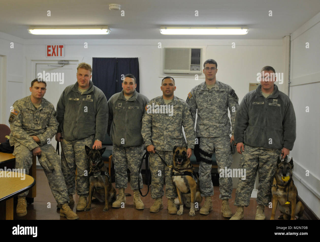 Members of the incoming and outgoing K-9 Teams pose for a picture after ...
