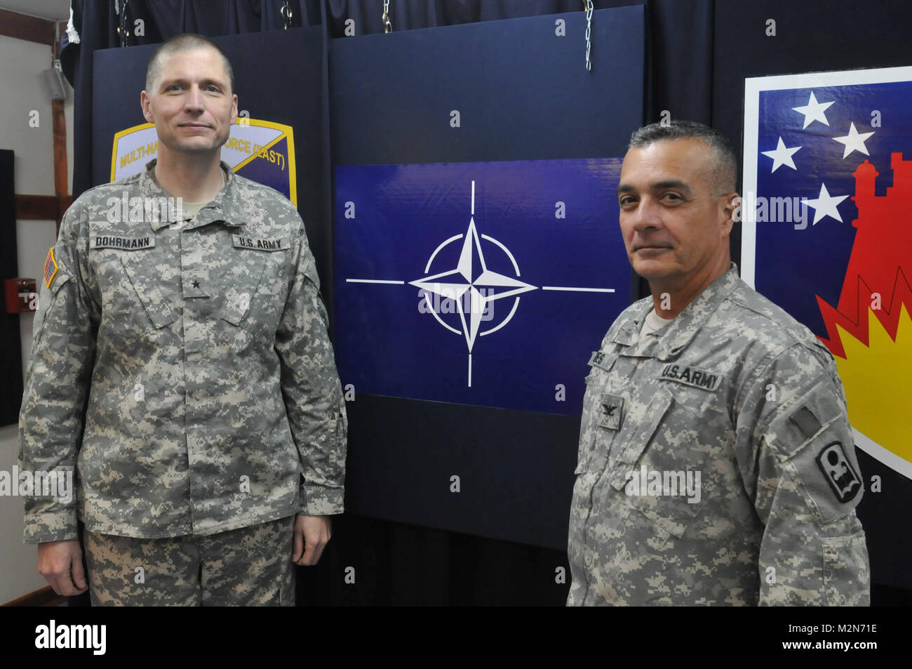 Commander of the 141st Maneuver Enhancement Brigade stands for a photo ...