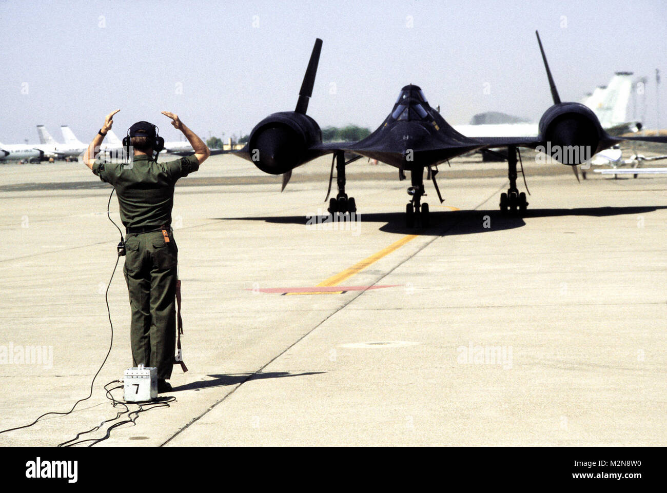 A ground crewman marshalls an SR-71 Blackbird being piloted by ...