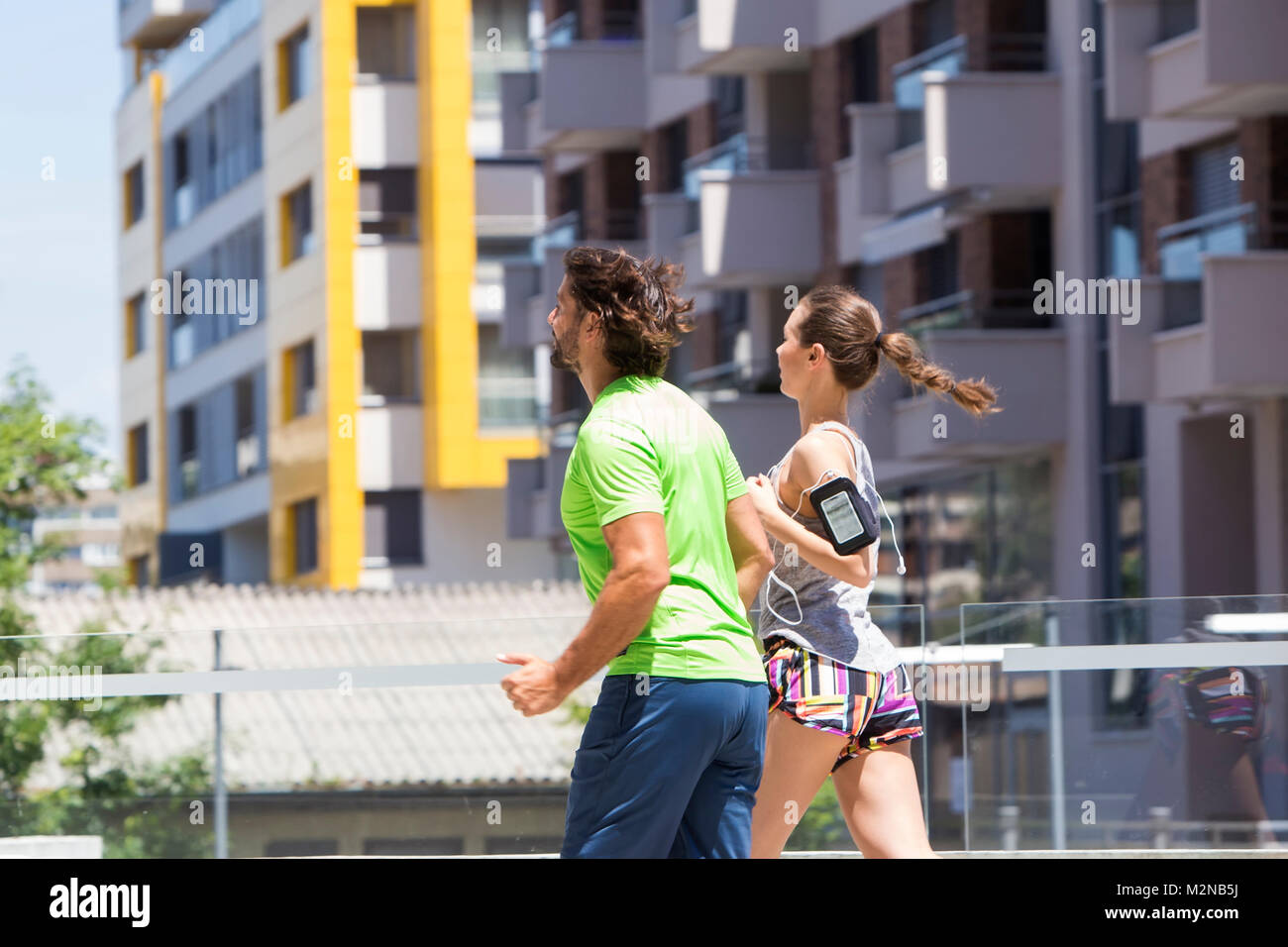 Couple running in urban enviroment at hot summer day Stock Photo - Alamy