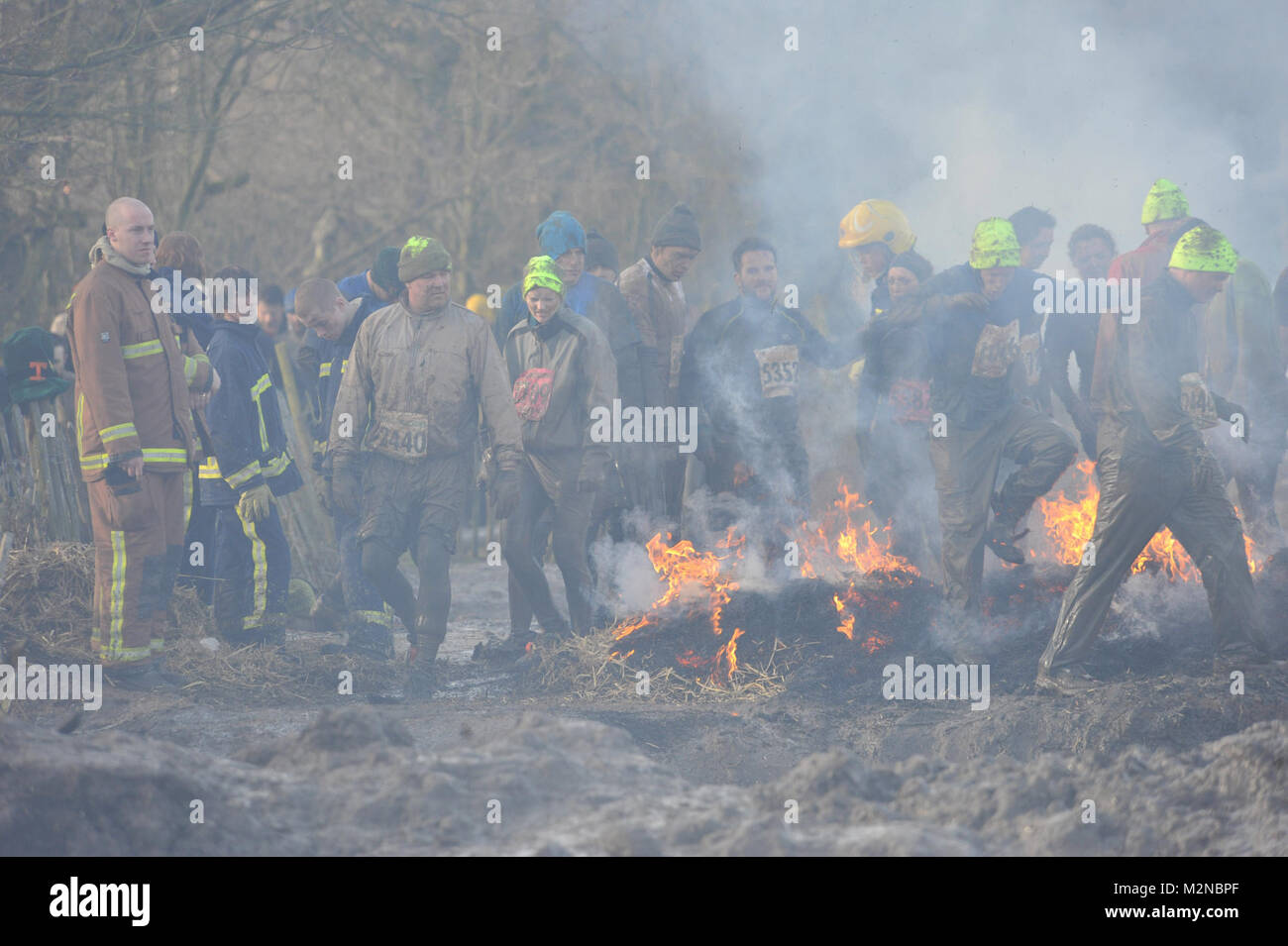 U.S. Navy sailors walk through fire during the Tough Guy Challenge by ...