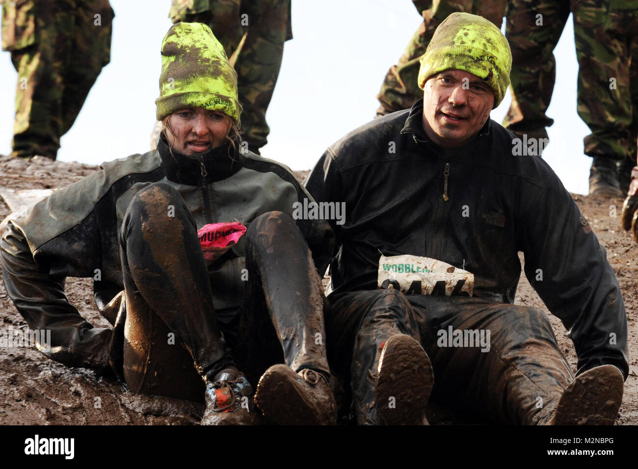 U.S. Navy Chief Petty Officers mudslide during the Tough Guy Challenge ...