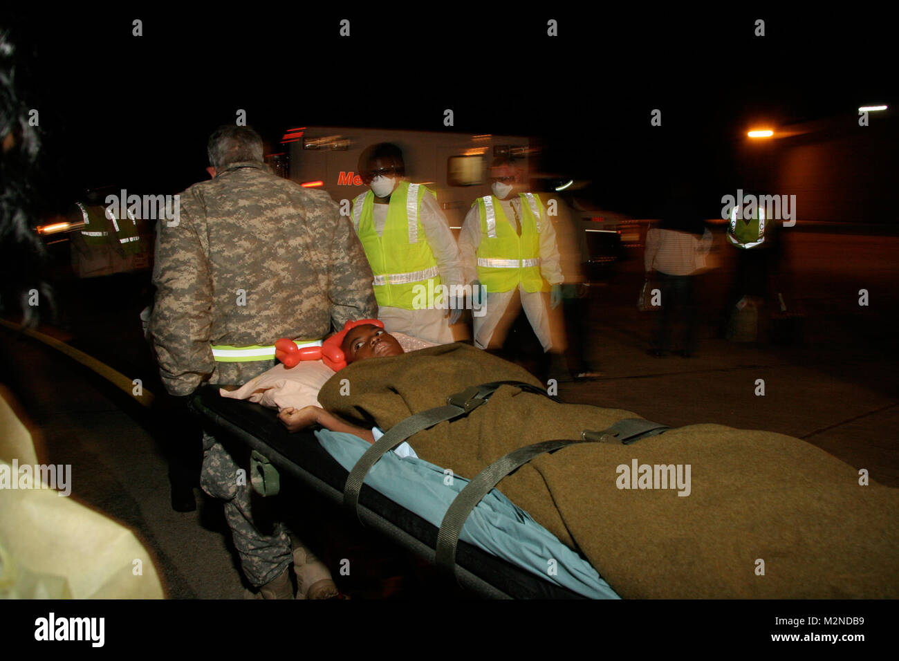 An SDF Trooper helps to unload injured Haitians in Atlanta by Georgia ...