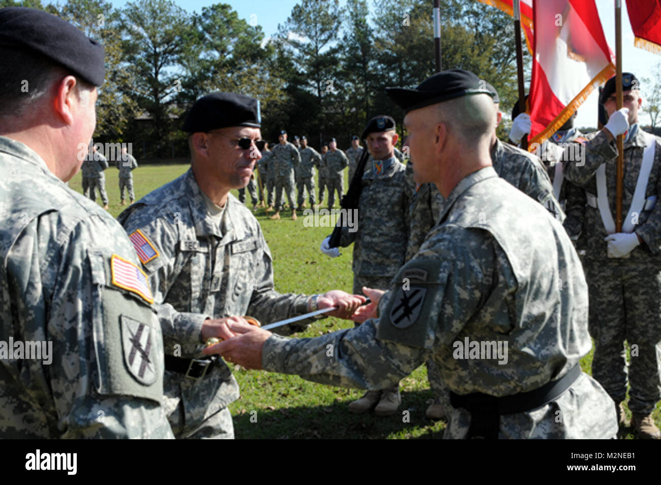 Command Sgt. Major Jospeh Recker center, receives the NCO sword from ...