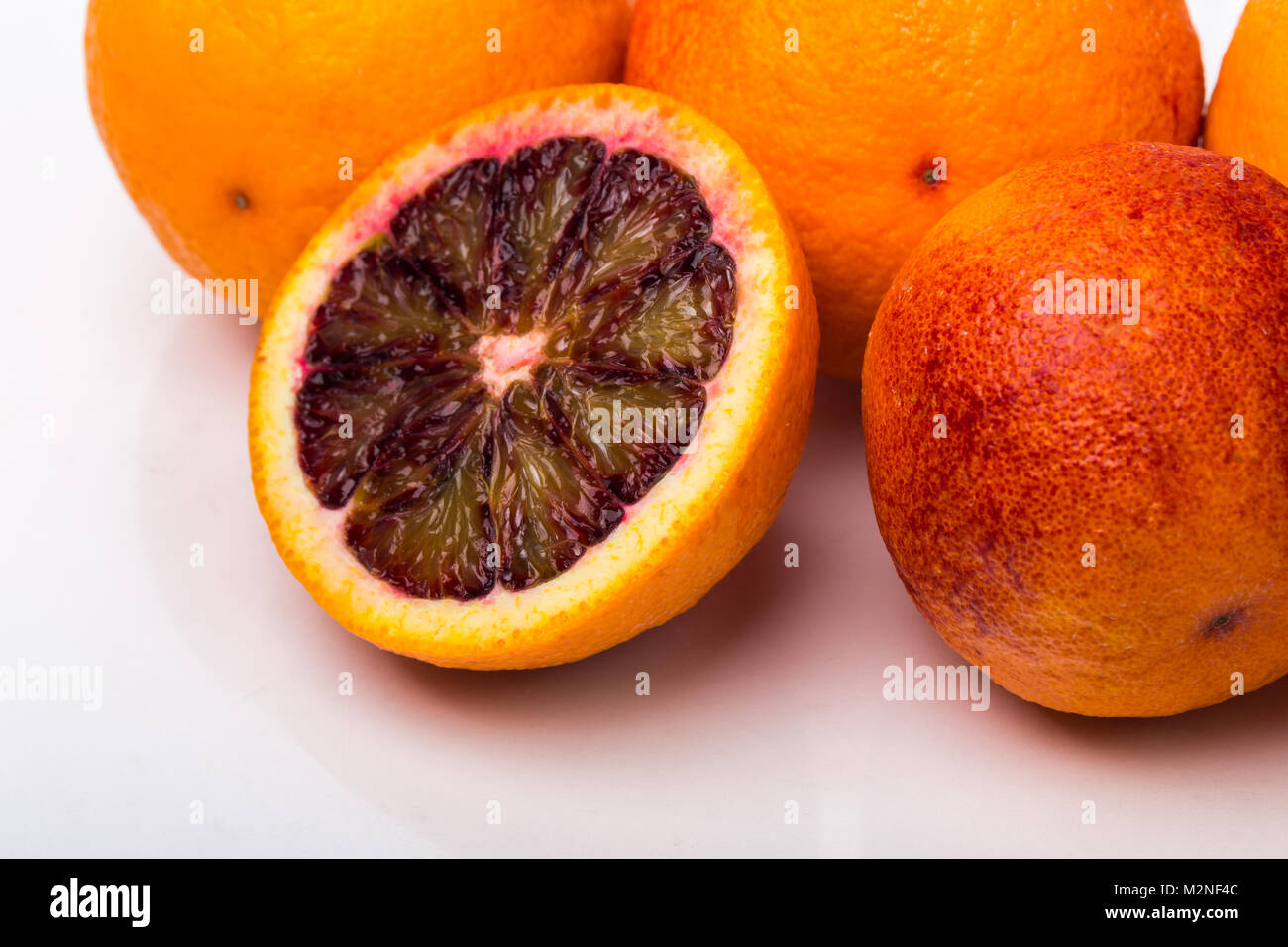 Bloody red oranges isolated on white background Stock Photo - Alamy