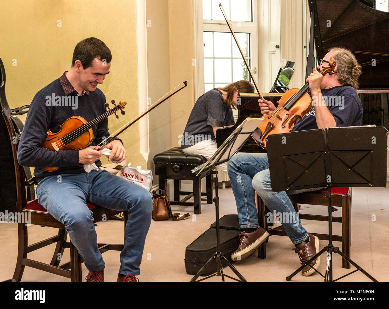Classical musicians laughing during rehearsals Stock Photo - Alamy