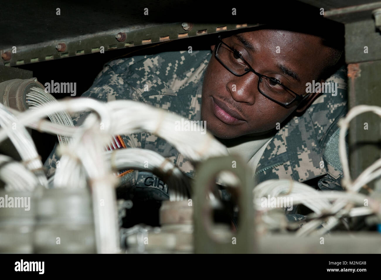 Spc. Chad Girtmon a 91B, Wheeled Mechanic from Lancaster, Texas, looks ...