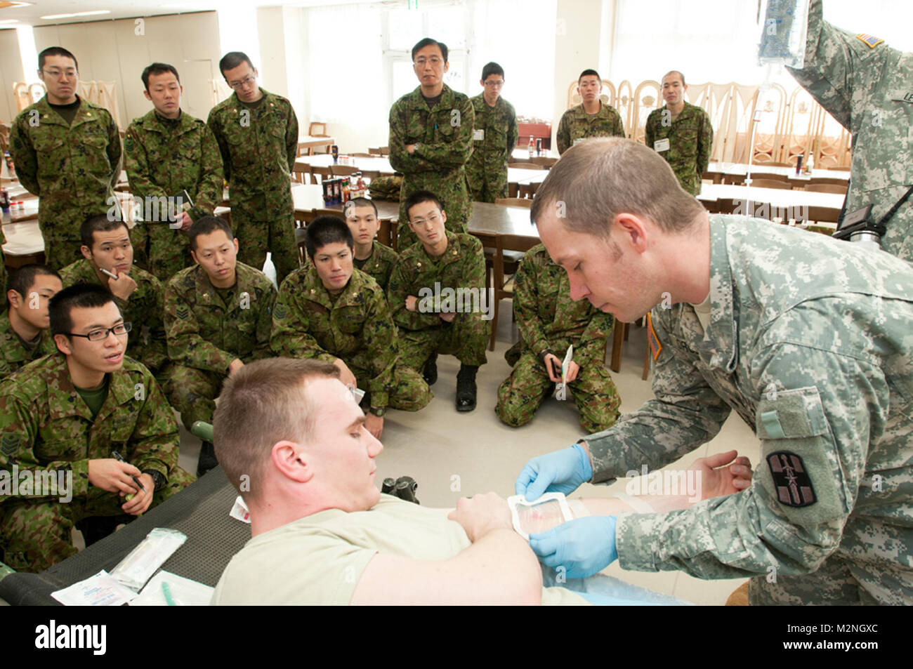Spc. John Droll, Medical NCO, 94th Combat Support Hospital, initiates ...