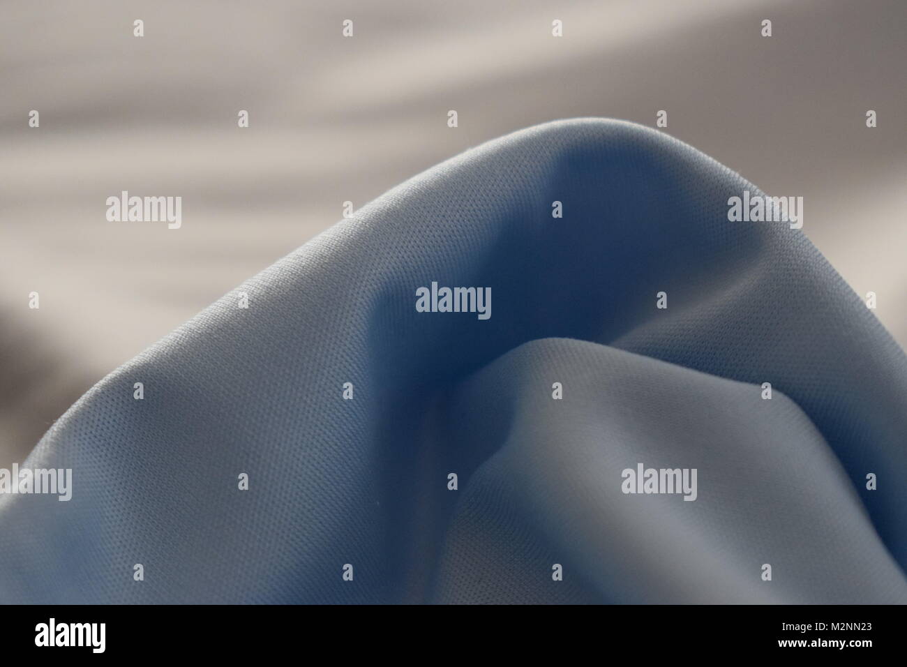 Light blue cloth closeup with grey background Stock Photo - Alamy