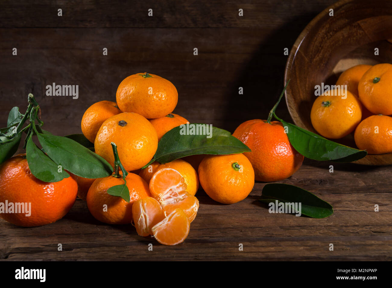 Delicious and beautiful mini Tangerines with Leaves on dark wooden ...