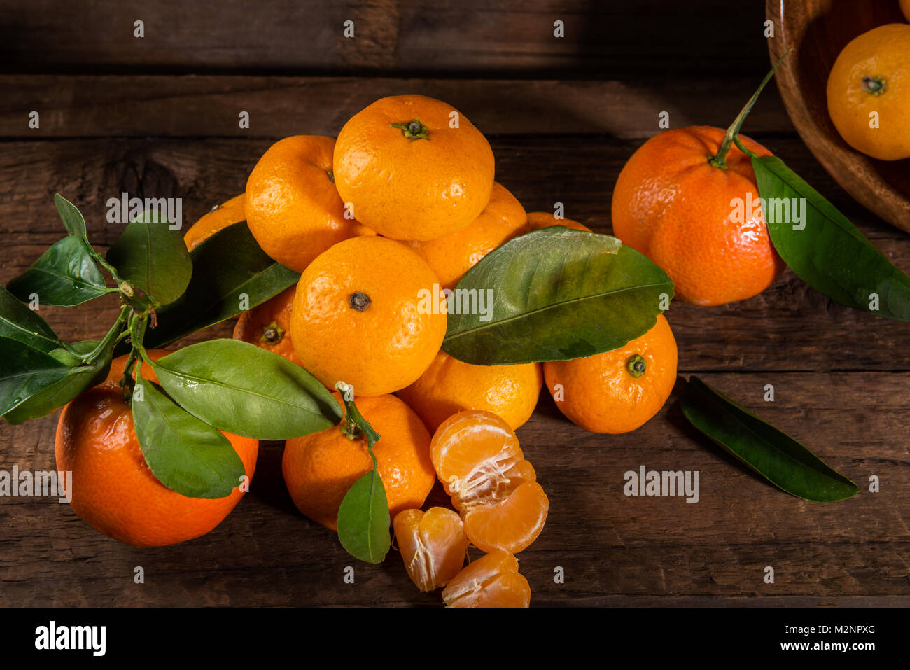 Delicious and beautiful mini Tangerines with Leaves on dark wooden ...