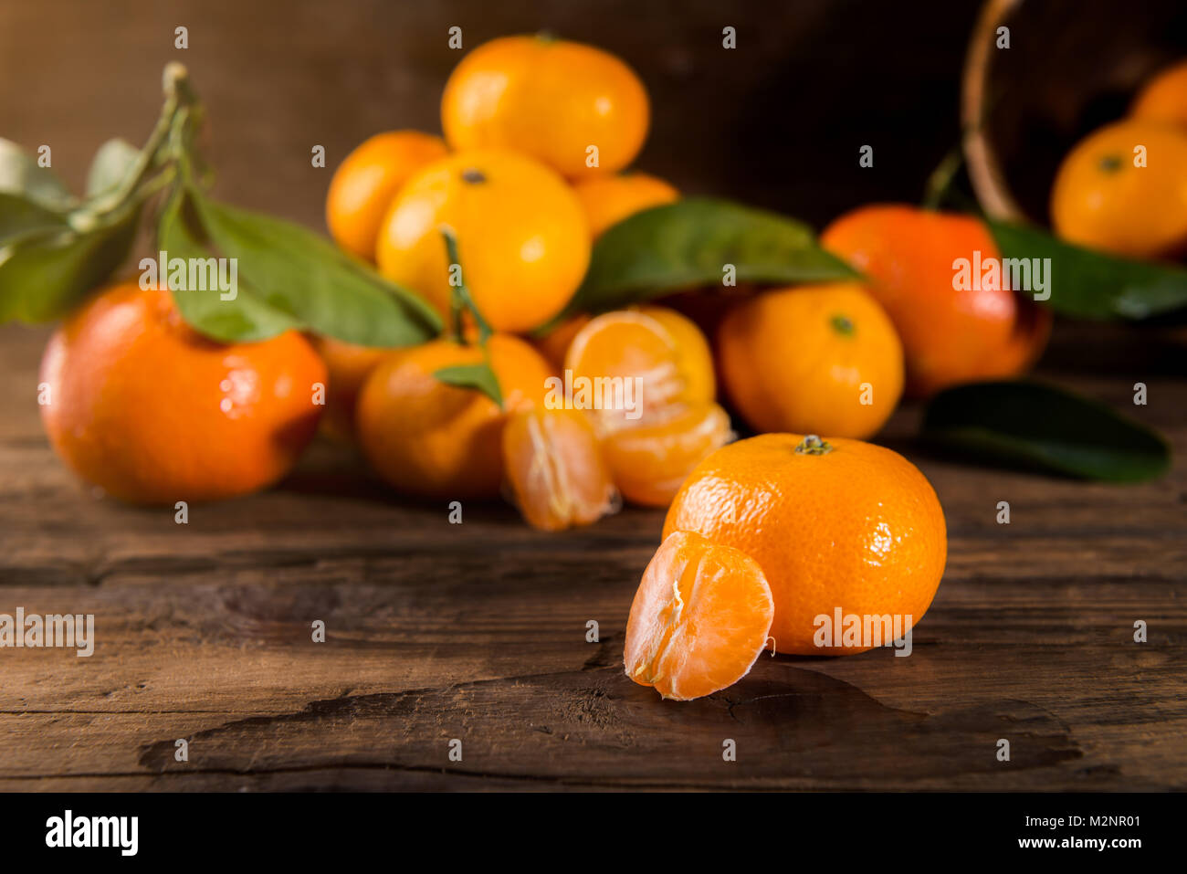 Delicious and beautiful mini Tangerines with Leaves on dark wooden ...