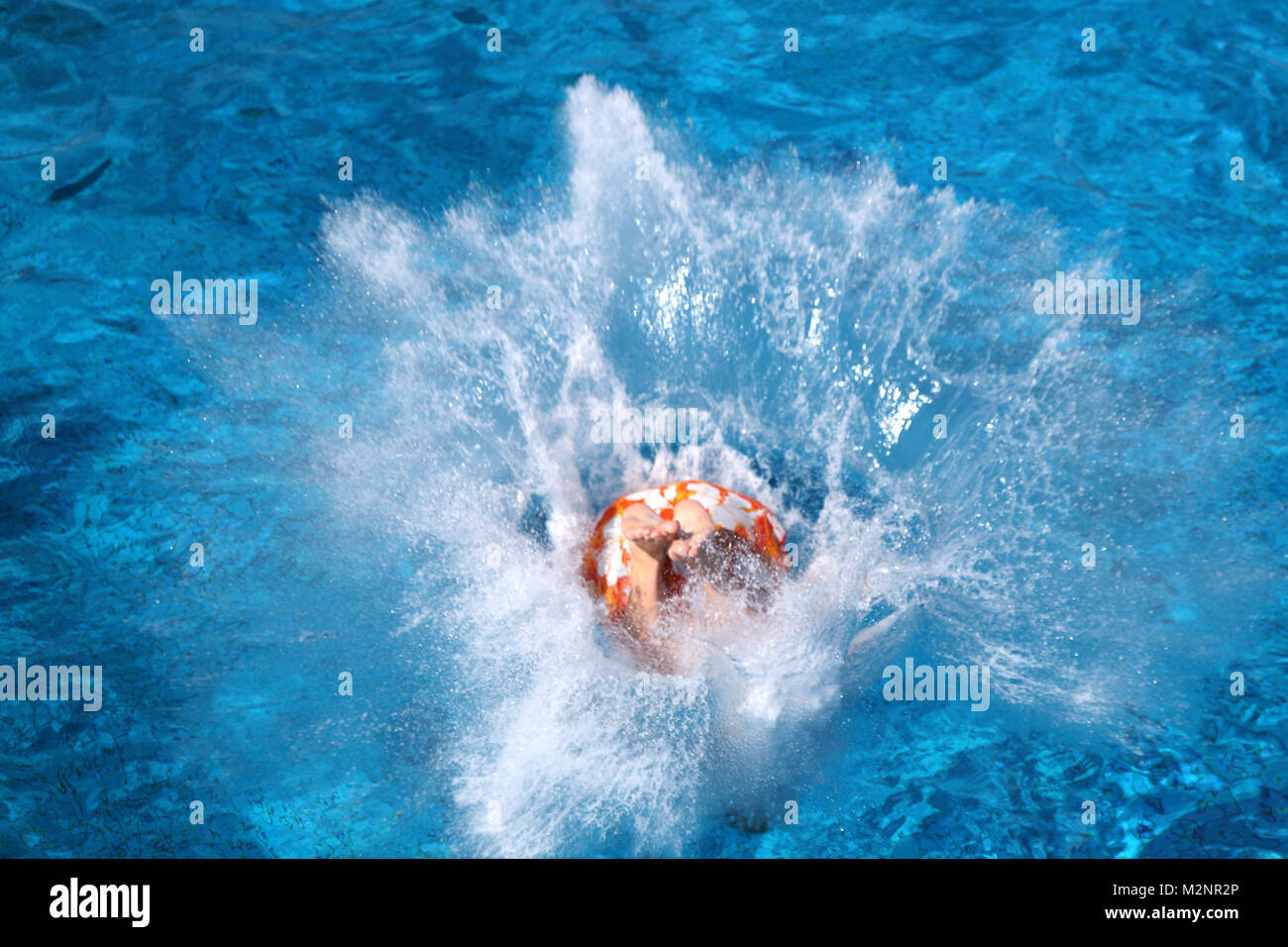 A boy jumps from a diving platform into the pool Stock Photo - Alamy