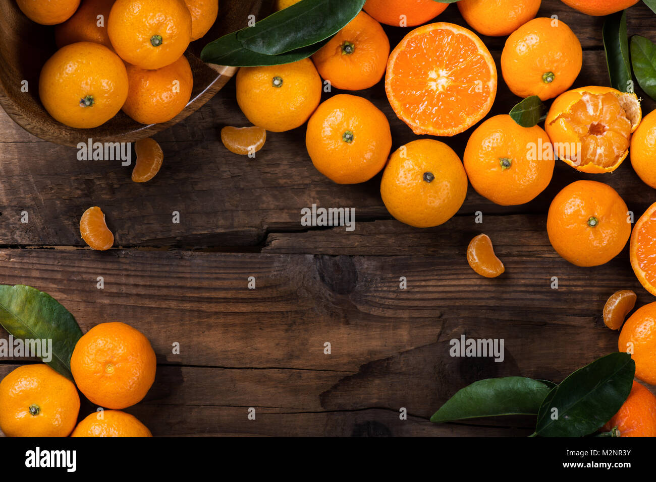 Delicious and beautiful mini Tangerines with Leaves on dark wooden ...