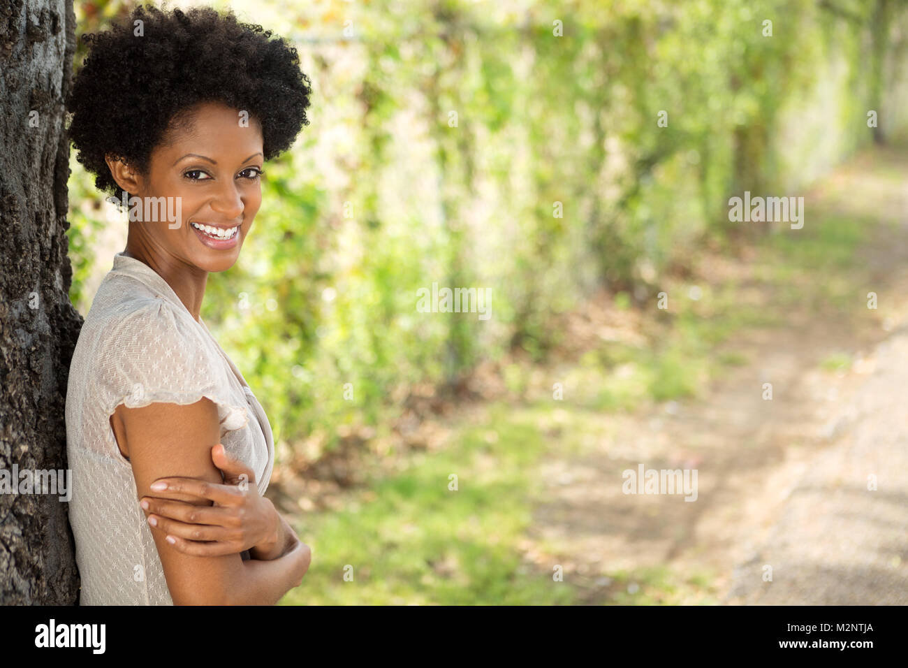 Beautiful woman smiling outside Stock Photo - Alamy