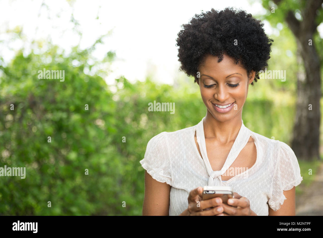 Beautiful woman smiling outside Stock Photo - Alamy