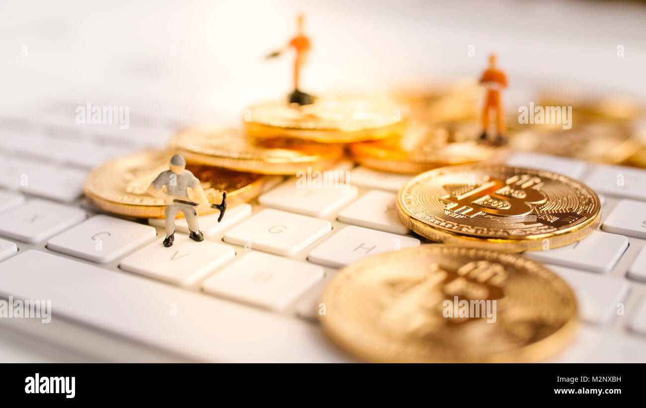 Bitcoin with little figure on keyboard Stock Photo - Alamy