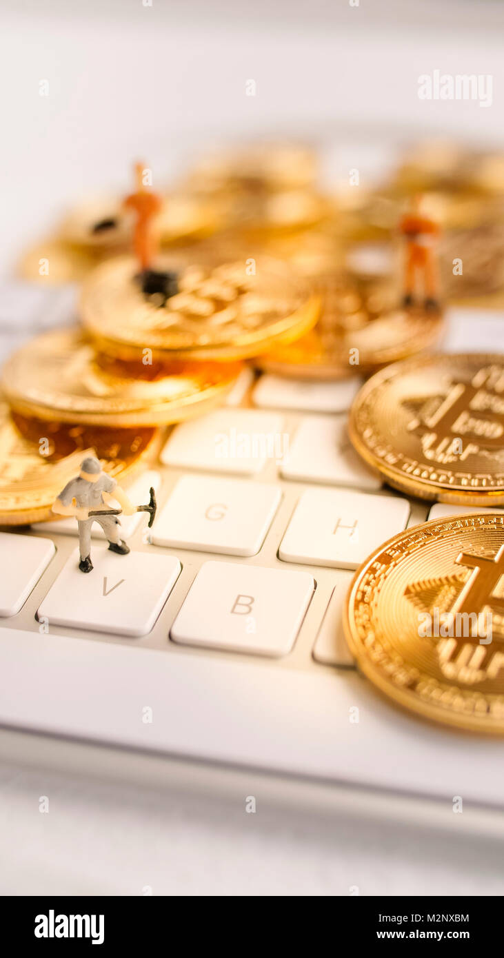 Bitcoin with little figure on keyboard Stock Photo - Alamy